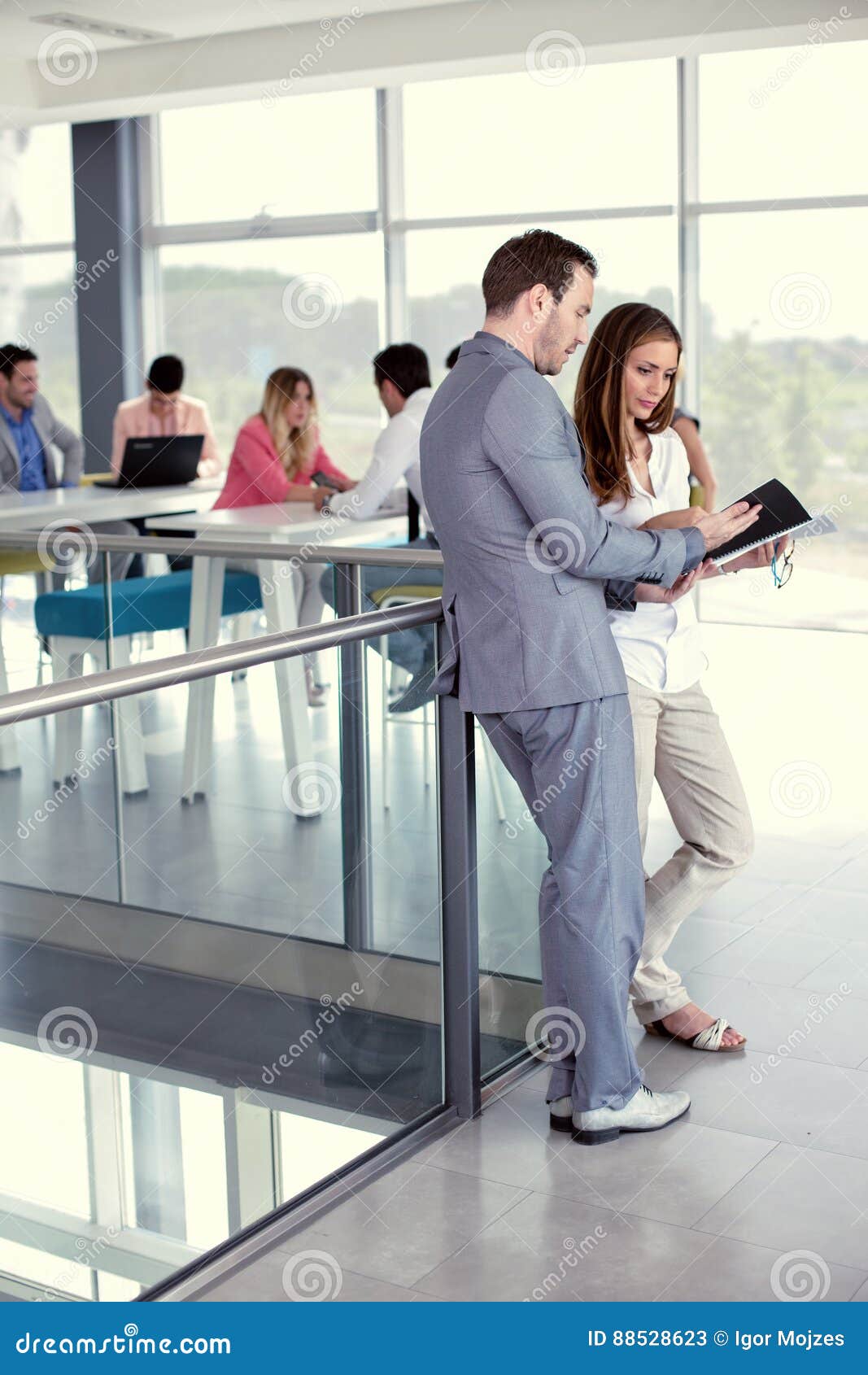 Two Business People Together Looking at Paperwork Stock Image - Image ...