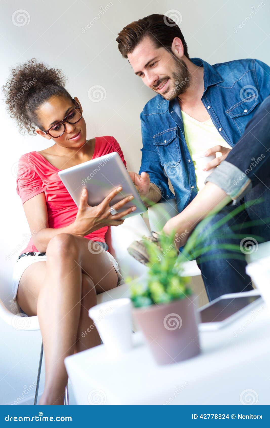 Two Business People Using a Digital Tablet at Office. Stock Photo ...