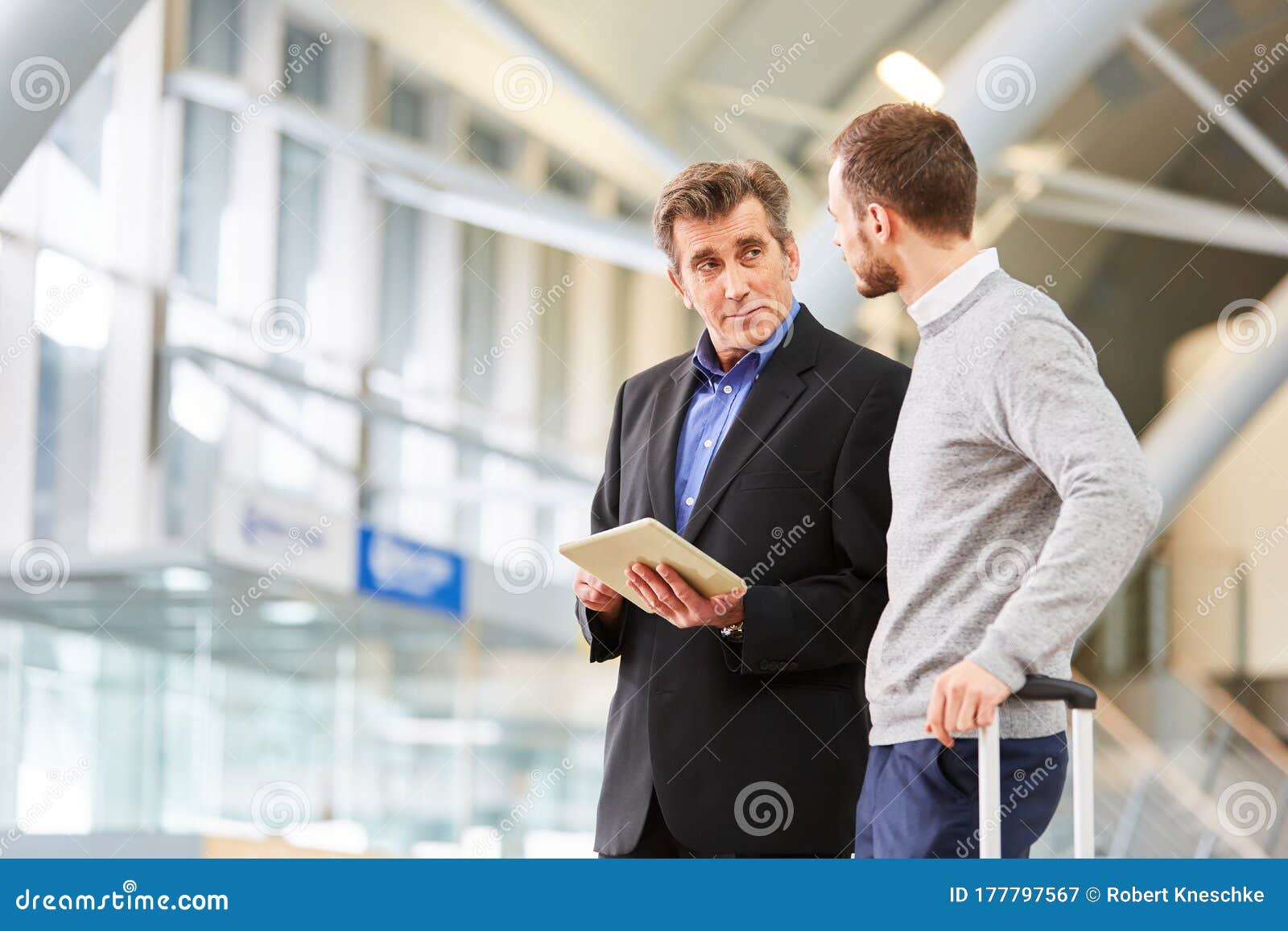 Two Business People Using Tablet at the Airport Stock Image - Image of ...