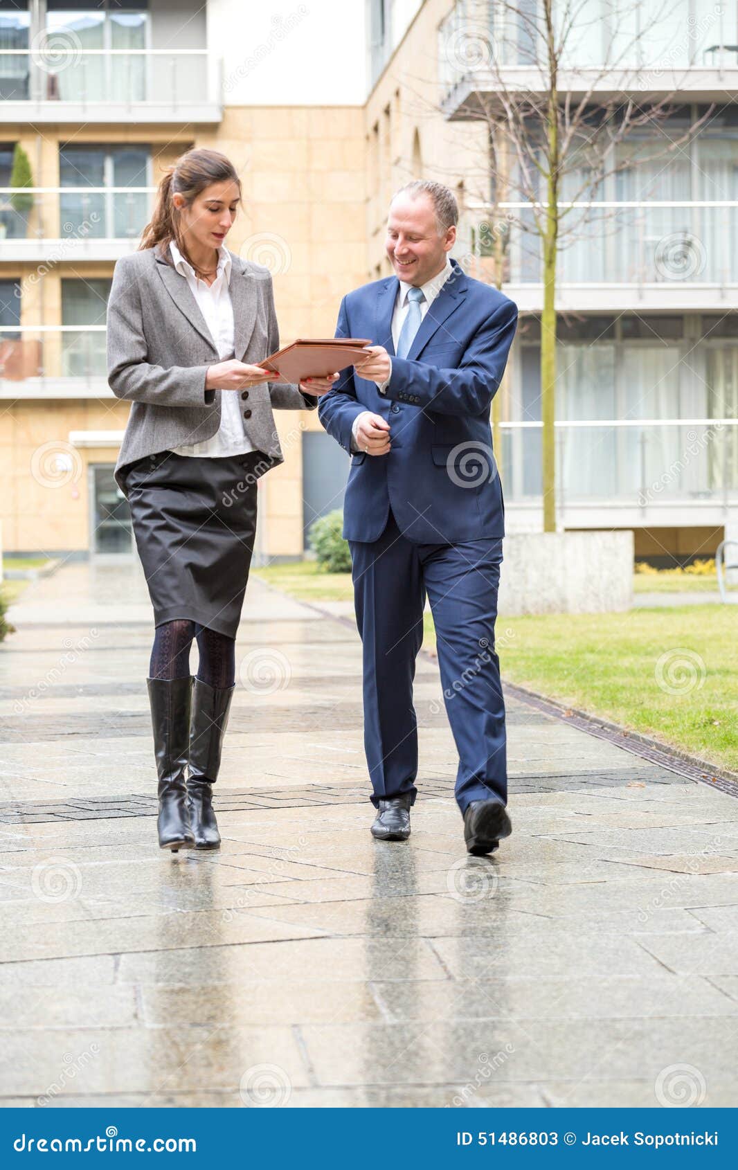 Two Business People Walking and Discussing Stock Image - Image of ...