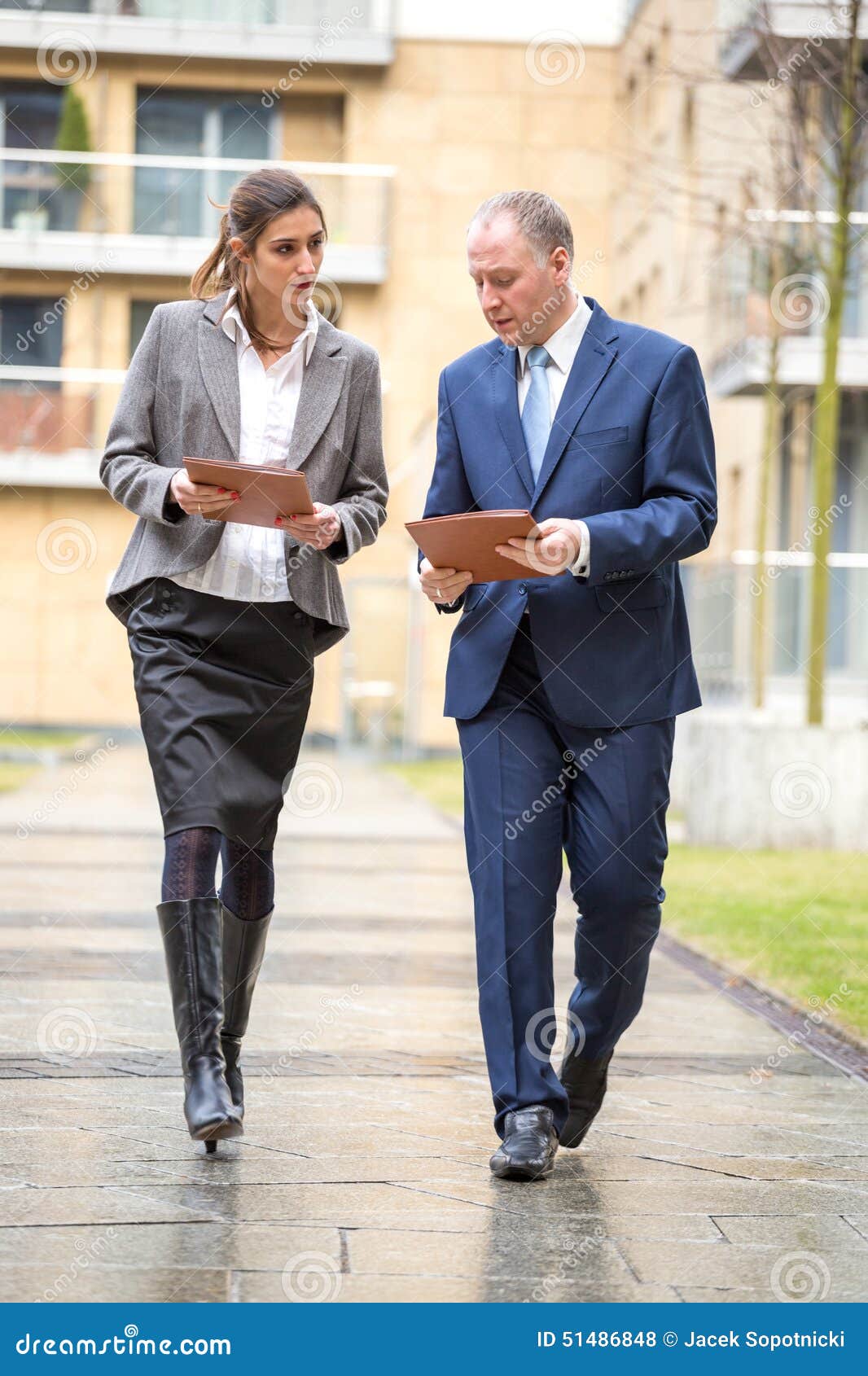 Two Business People Walking and Discussing Stock Photo - Image of ...