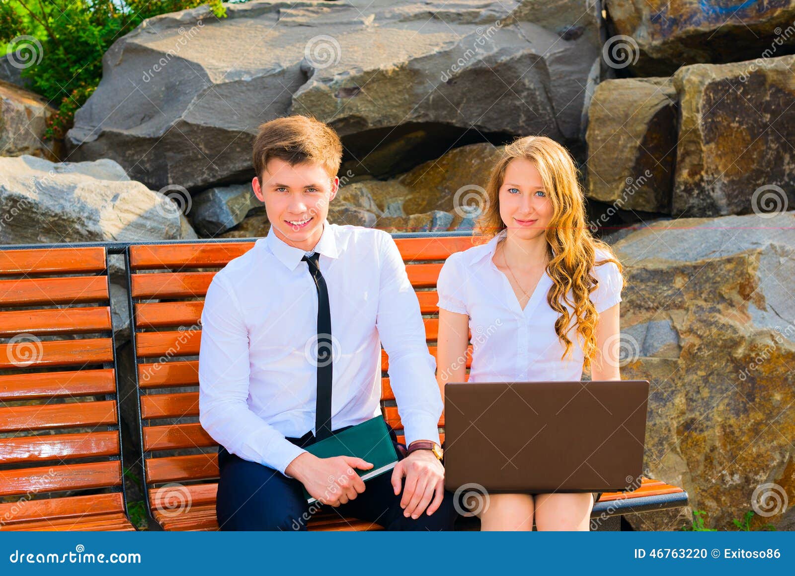 Two Business People Working on a Laptop Stock Photo - Image of bench ...