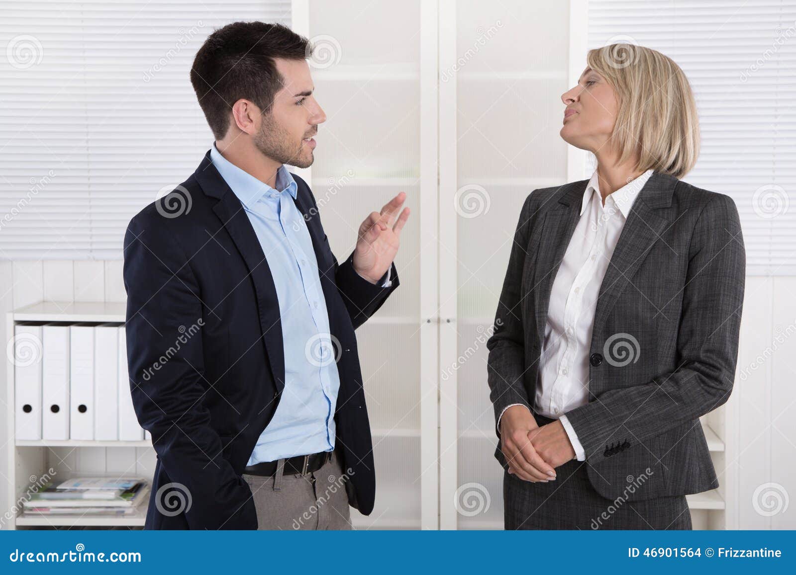 Two Business People Working in a Team Talking Together in the of Stock ...