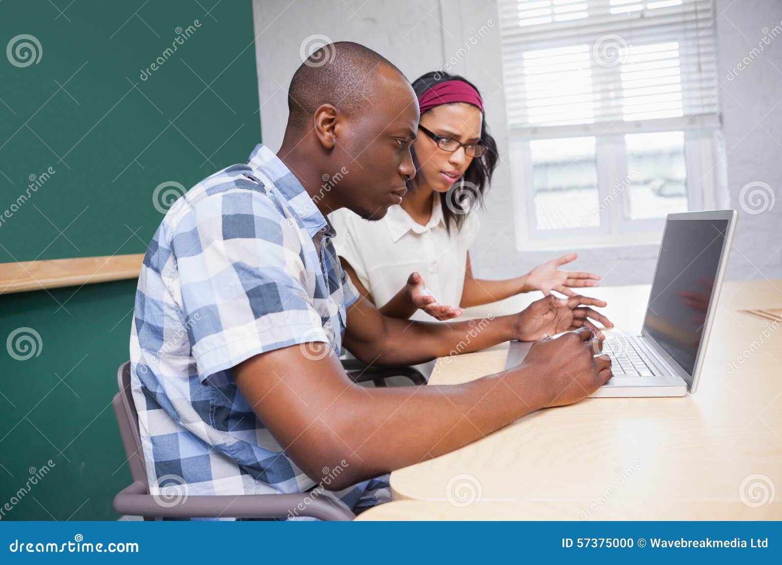 Two Business People Working Together on a Laptop Stock Photo - Image of ...