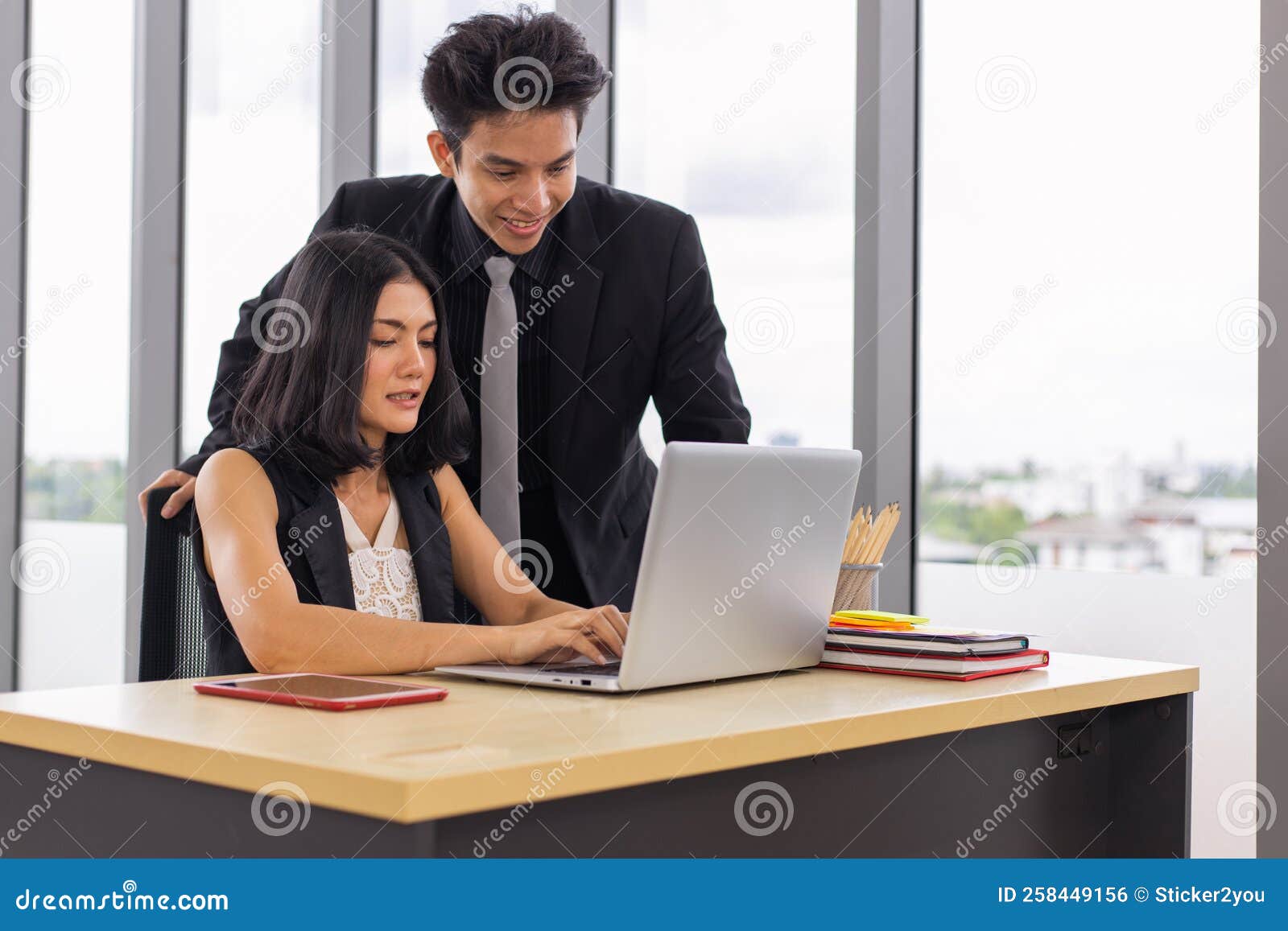 Two Business People Working Together with Smile on Face Using Laptop at ...