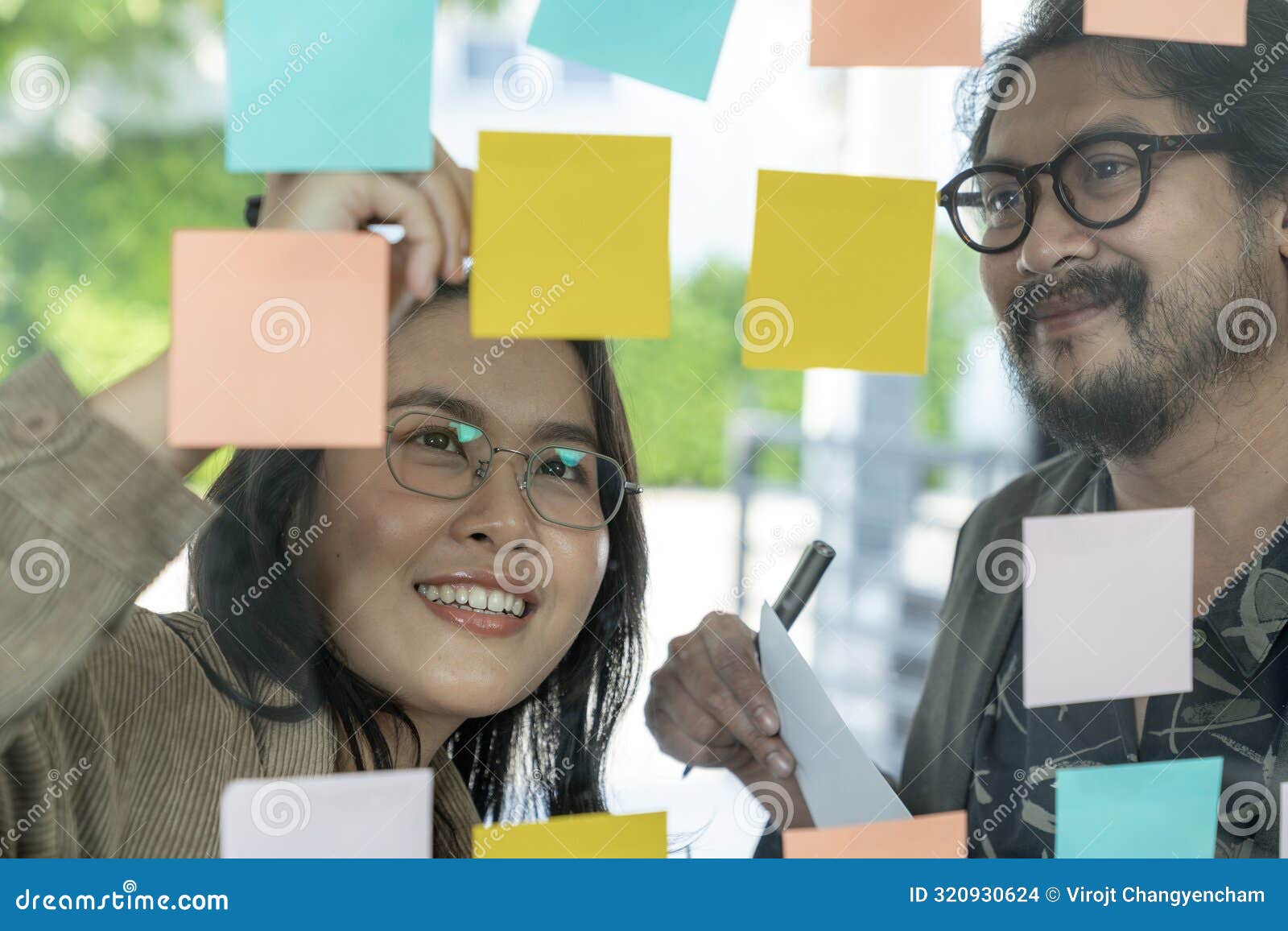 Two Business People Writing Business Idea into Sticky Note Stock Photo ...
