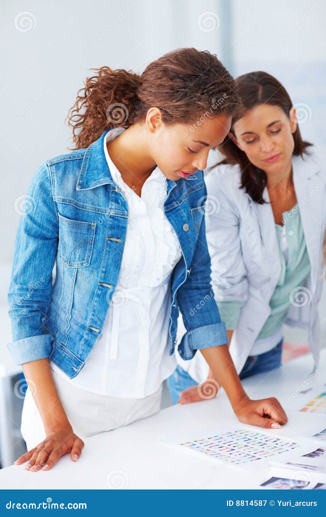 Two Business Woman Working on a Project Together Stock Image - Image of ...