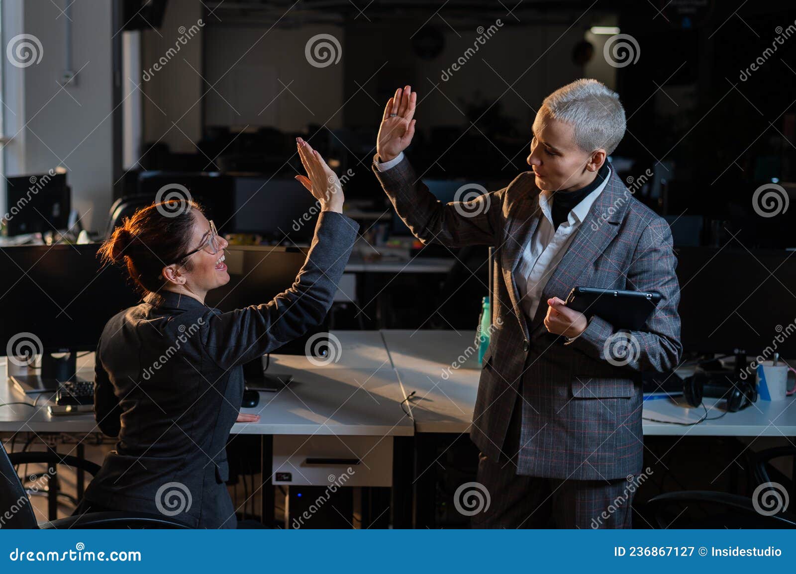 Two Business Women Give a High Five in the Office. Stock Image - Image ...