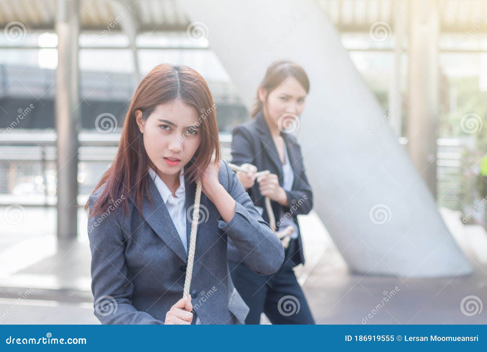 Two Business Women Pulling a Rope Competing with Commitment To Winer ...