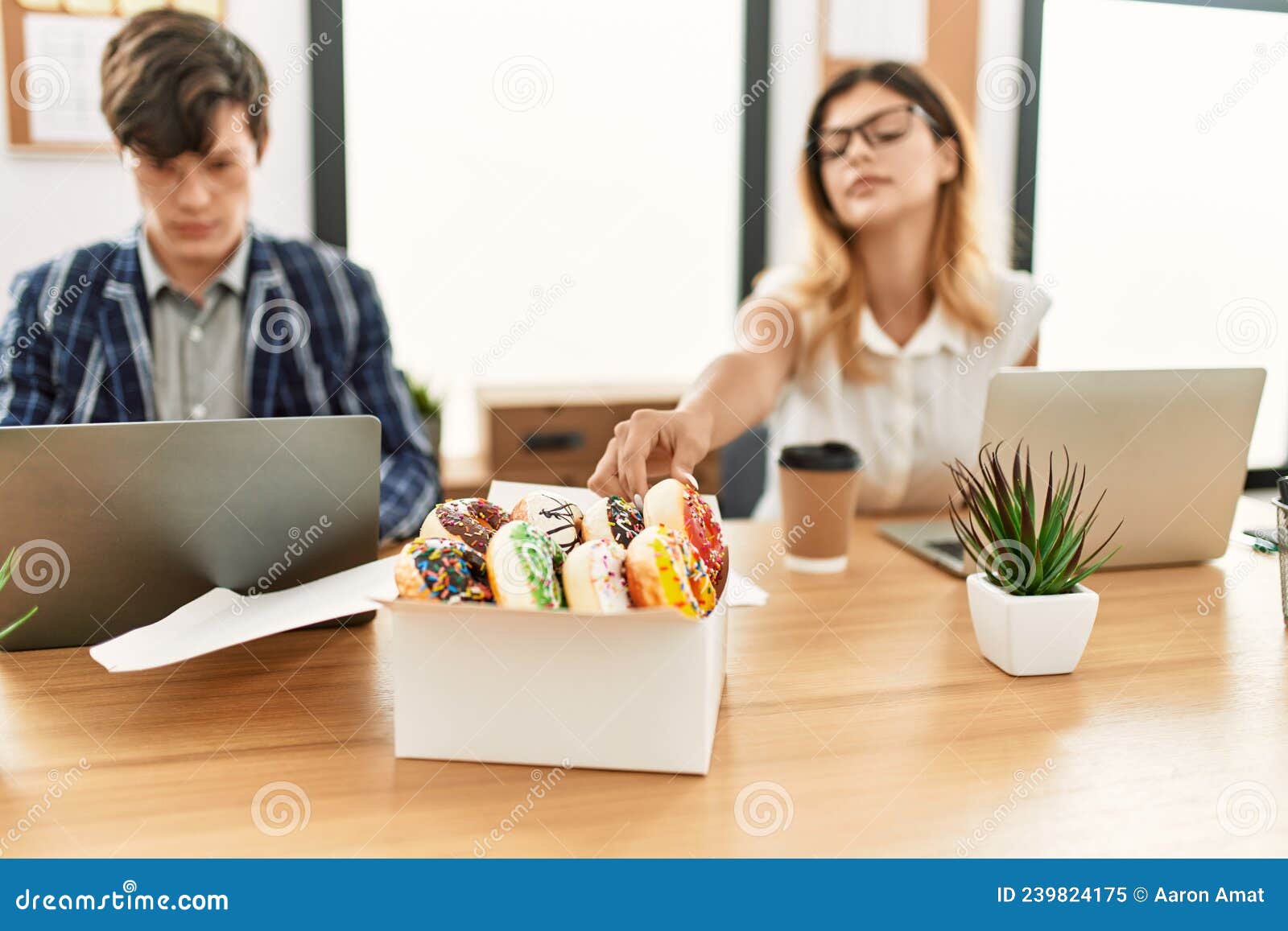 Two Business Workers Smiling Happy Eating Doughnuts at the Office Stock ...