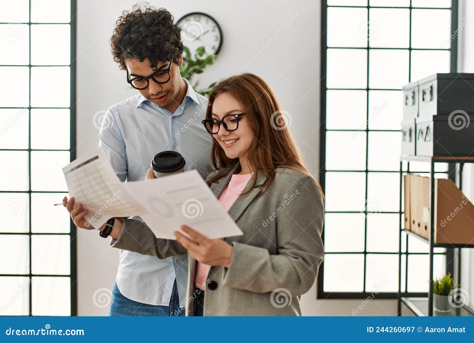 Two Business Workers Smiling Happy Reading Paperwork Working at the ...