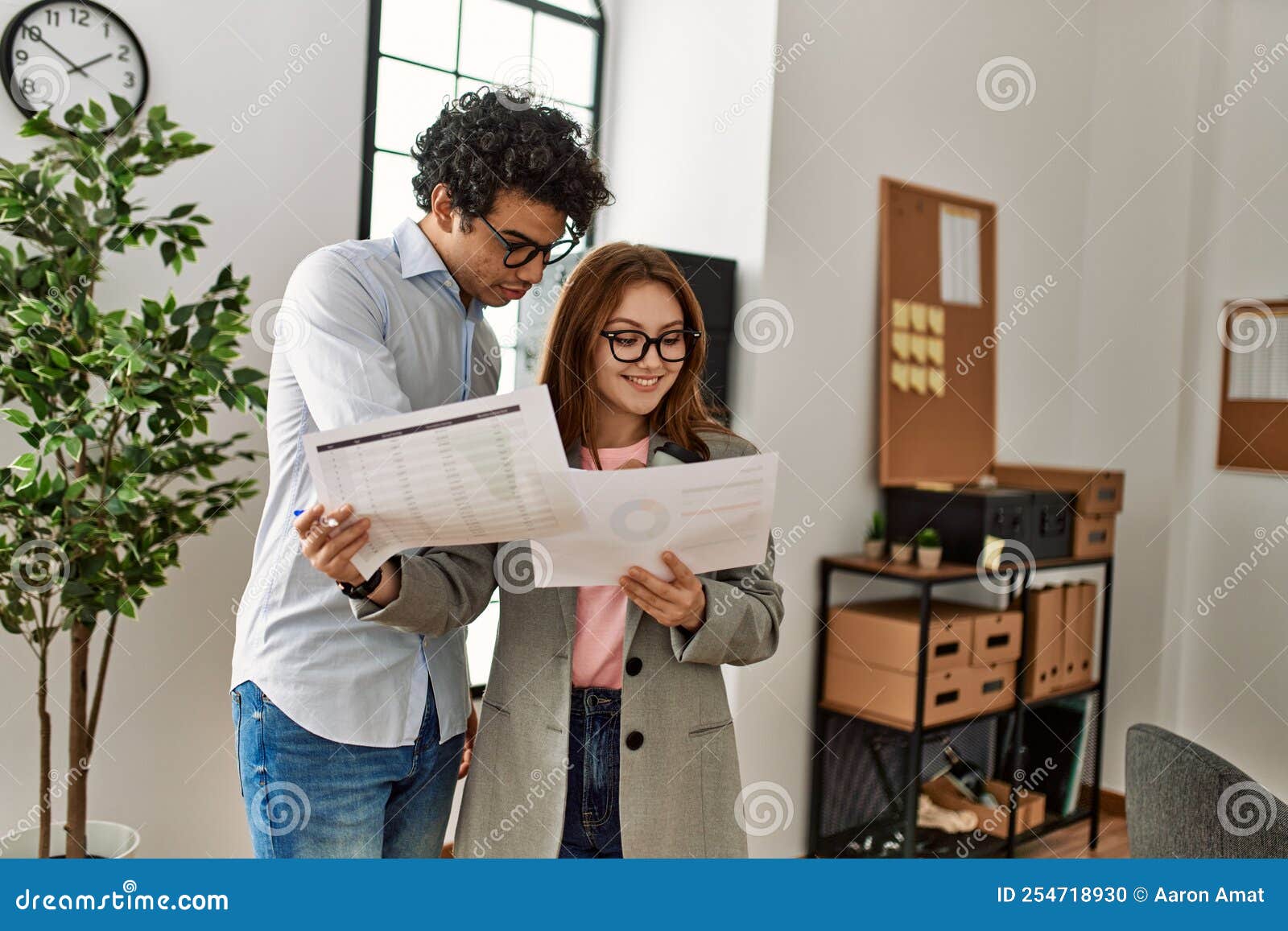 Two Business Workers Smiling Happy Reading Paperwork Working at the ...