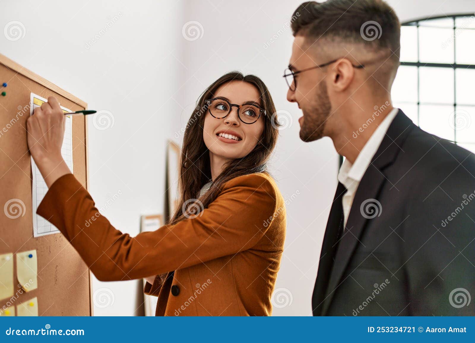 Two Business Workers Smiling Happy Writing on Corkboard Reminder at the ...