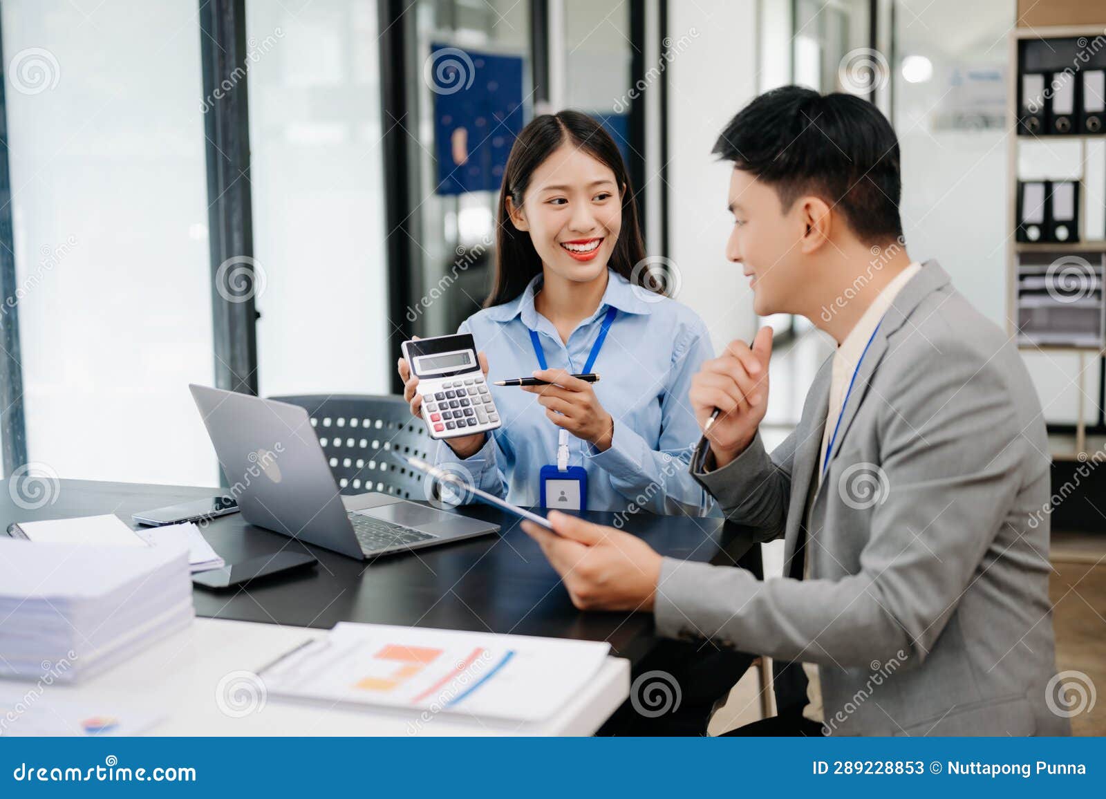 Two Business Workers Talking on the Smartphone, Calculator and Using ...