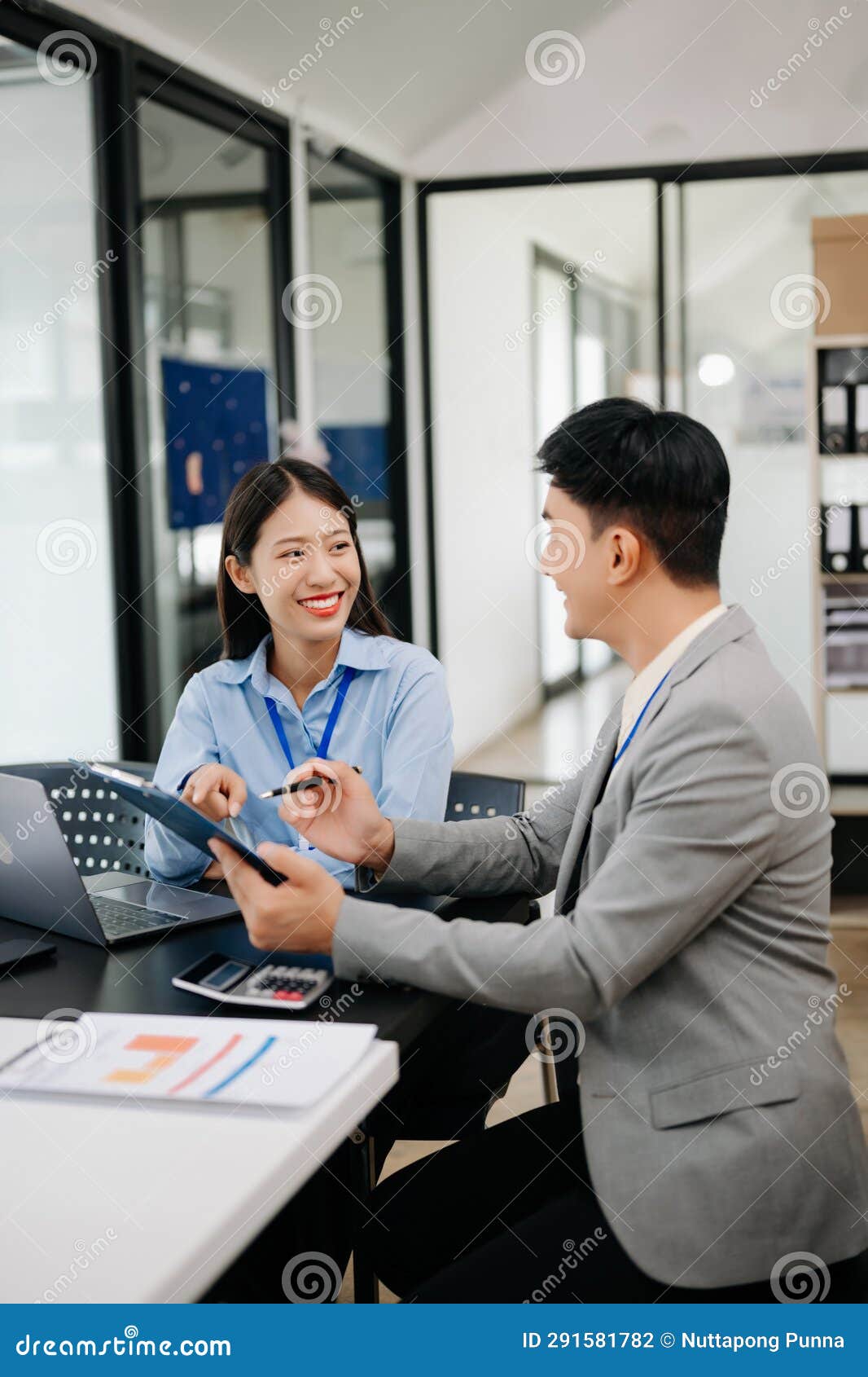 Two Business Workers Talking on the Smartphone, Calculator and Using ...