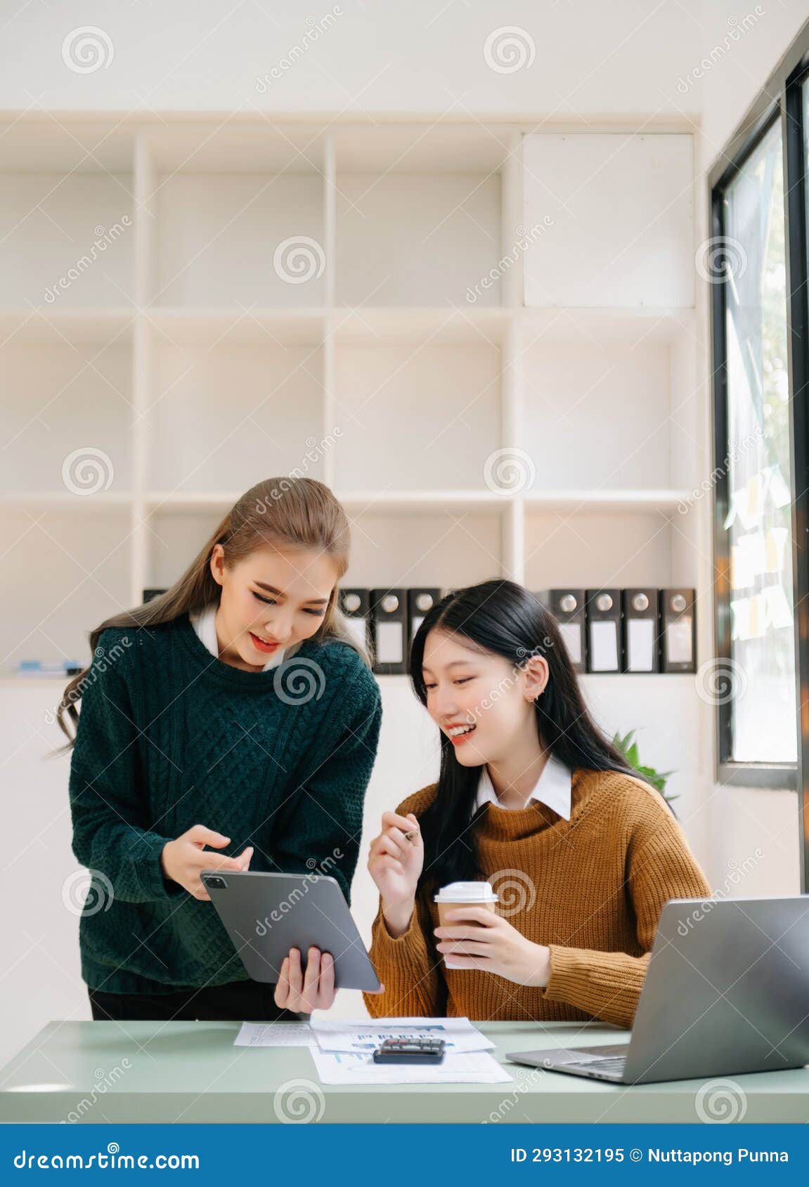 Two Business Workers Talking on the Smartphone, Tablet and Using Laptop ...
