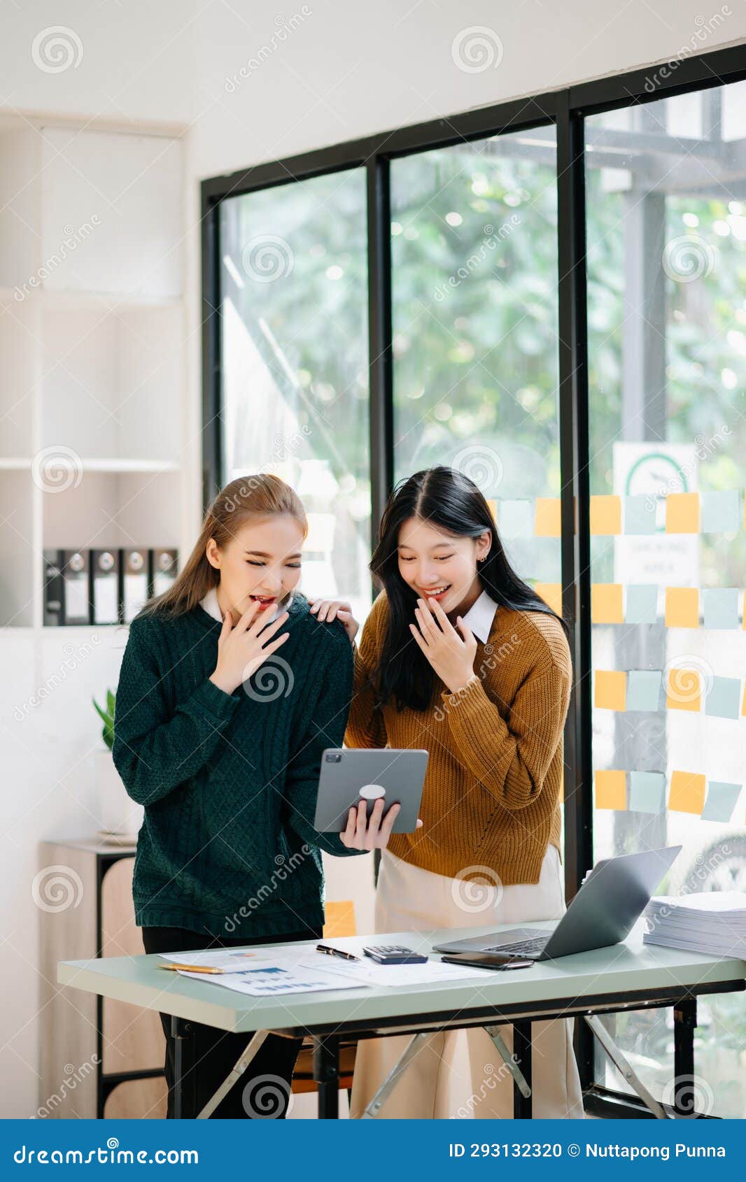 Two Business Workers Talking on the Smartphone, Tablet and Using Laptop ...