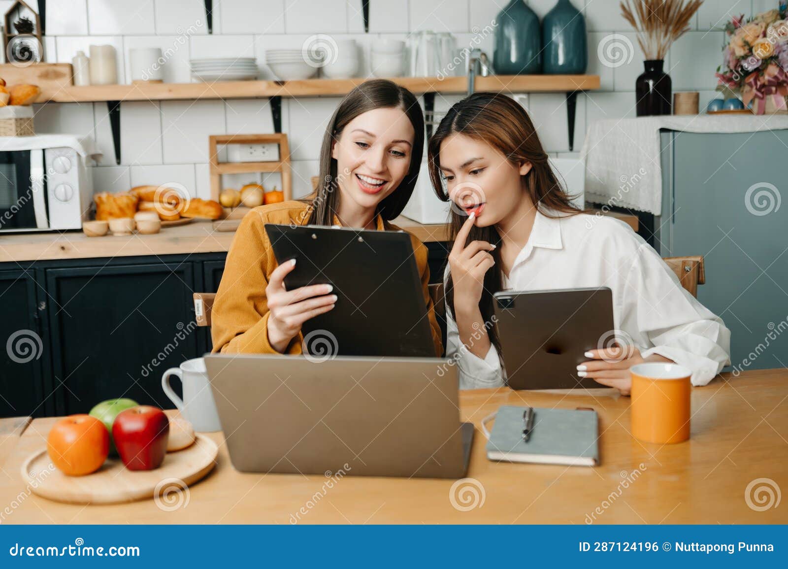 Two Business Workers Talking on the Smartphone and Using Laptop at the ...