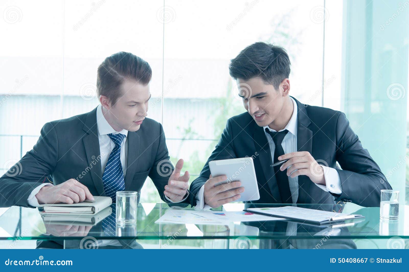 Two Businessman Using Tablet in Meeting Stock Image - Image of elegant ...