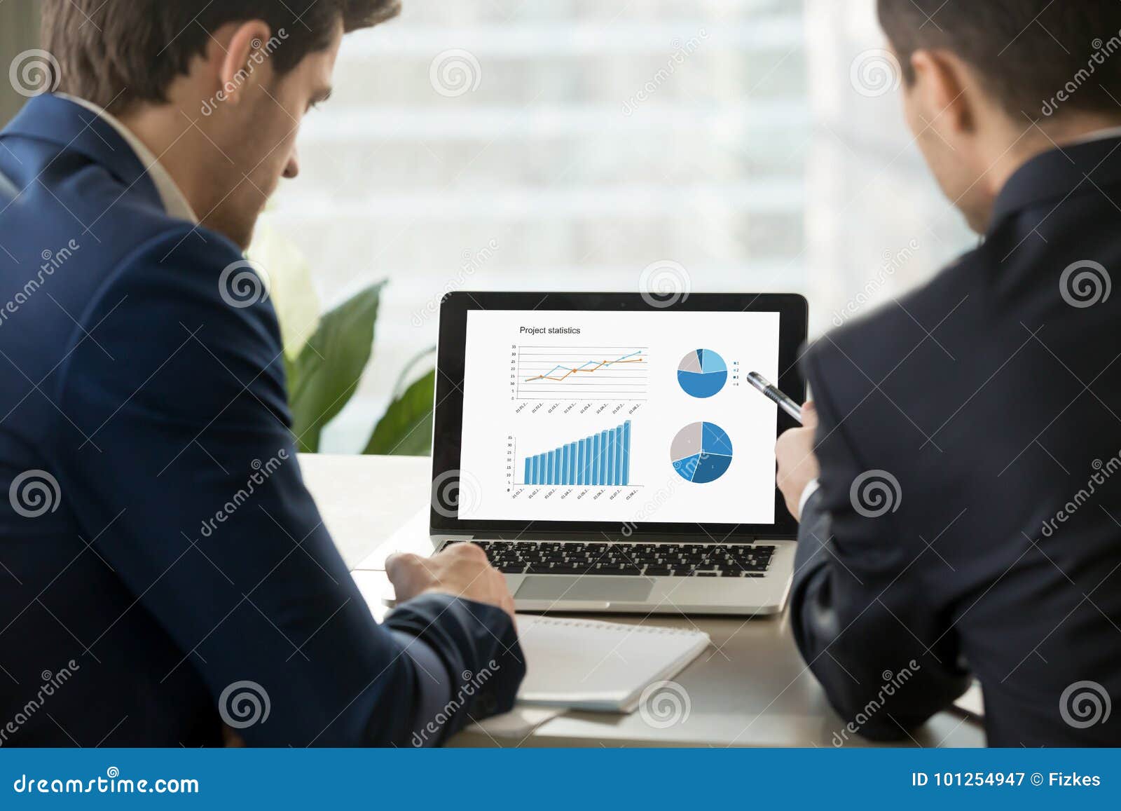 Two Businessmen Analyzing Project Statistics on Laptop Screen. Stock ...