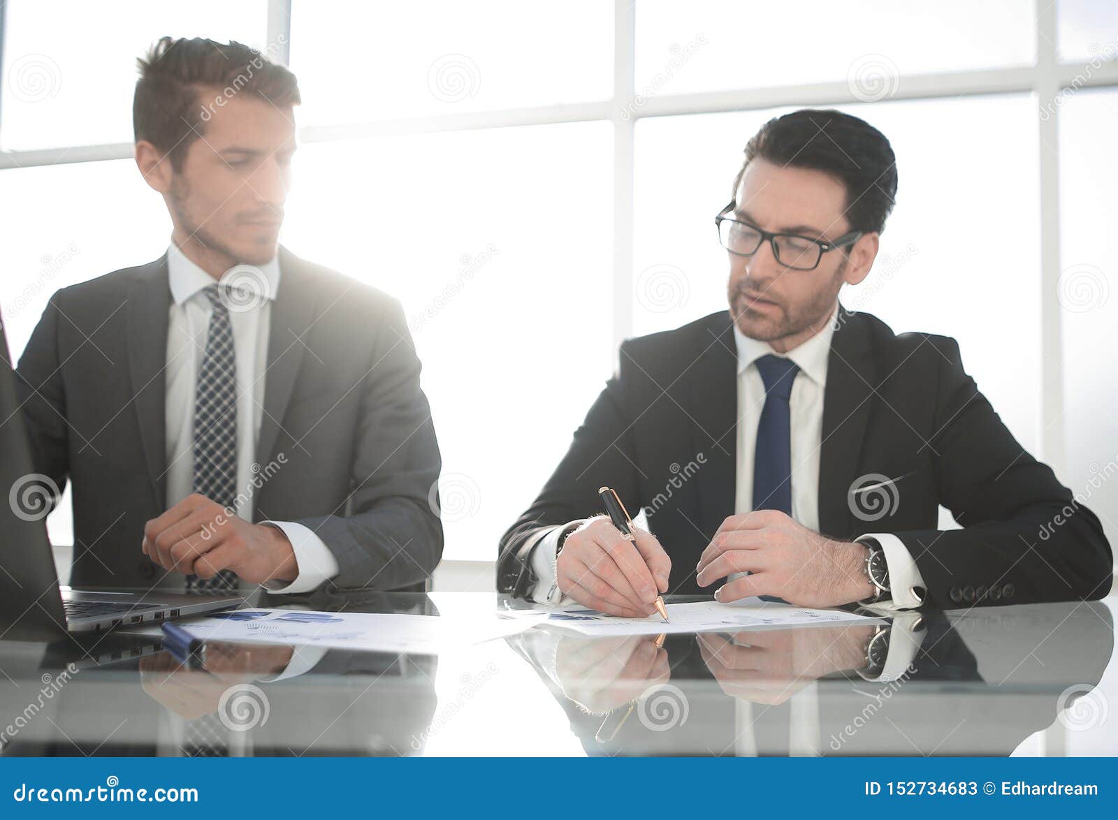 Two Businessmen Discuss Financial Documents Stock Image - Image of ...
