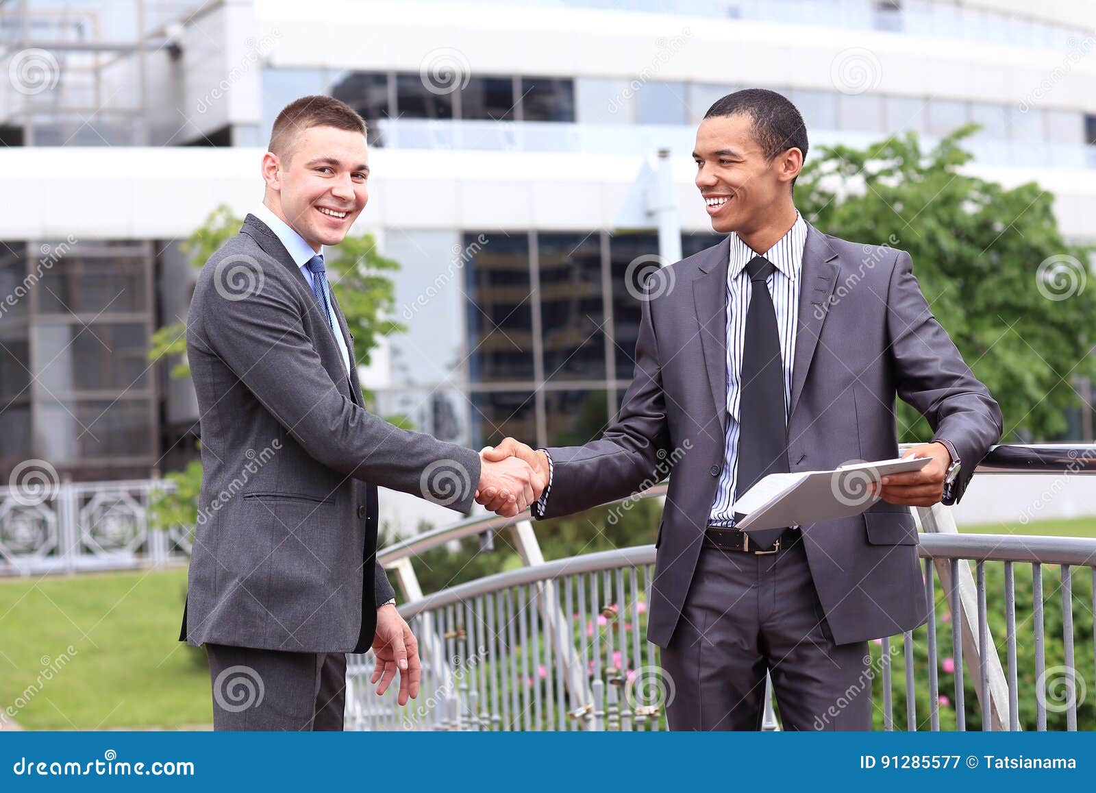 Two Businessmen Discussing Document Outside Office Stock Image - Image ...
