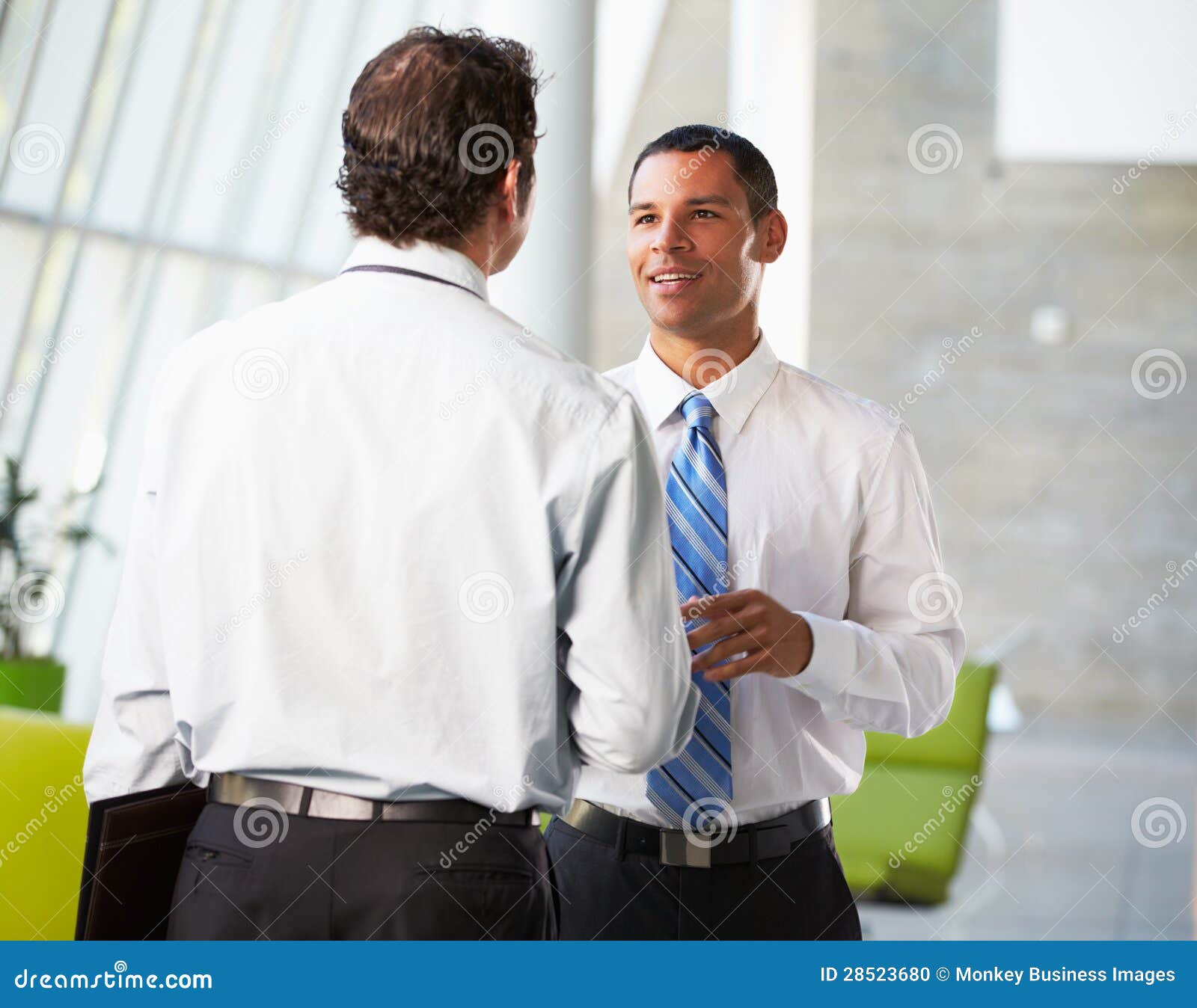 Two Businessmen Having Informal Meeting in Modern Office Stock Photo ...