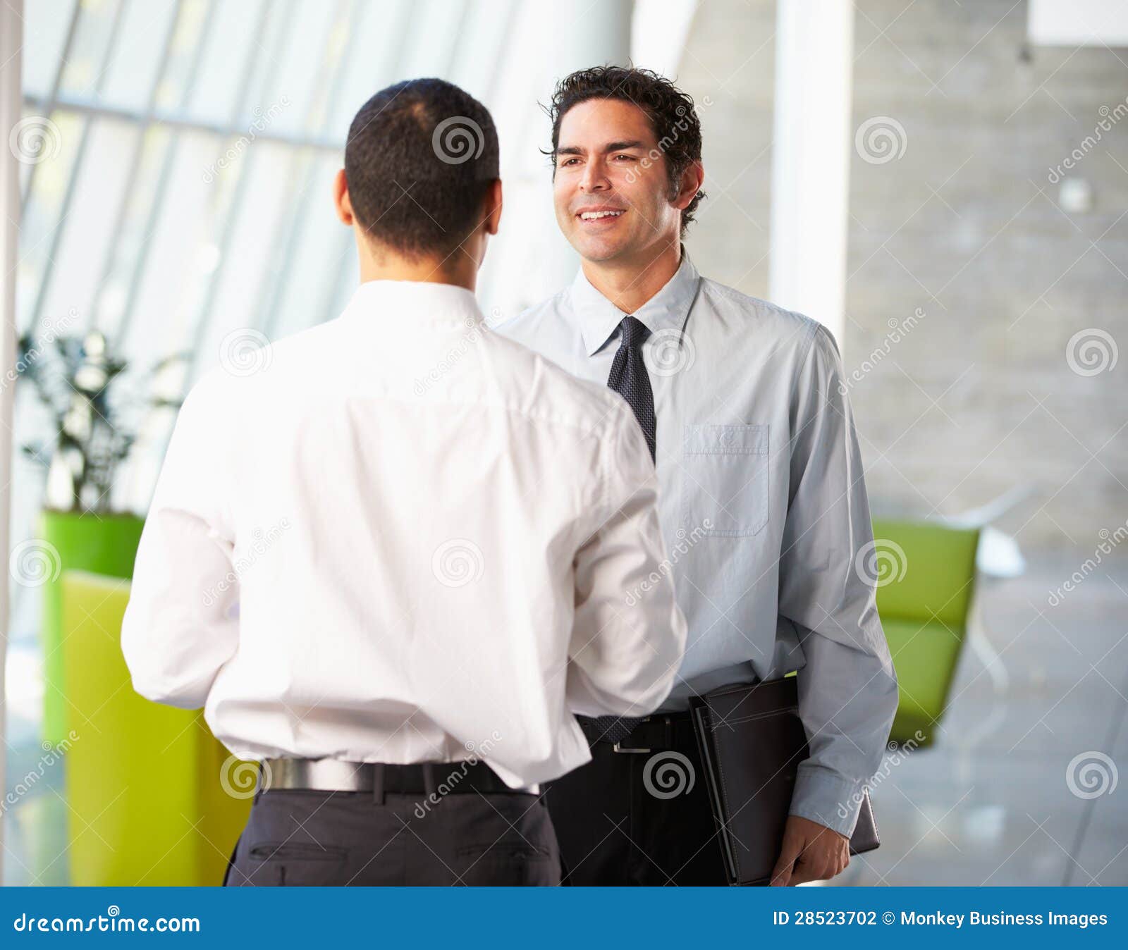 Two Businessmen Having Informal Meeting in Modern Office Stock Photo ...