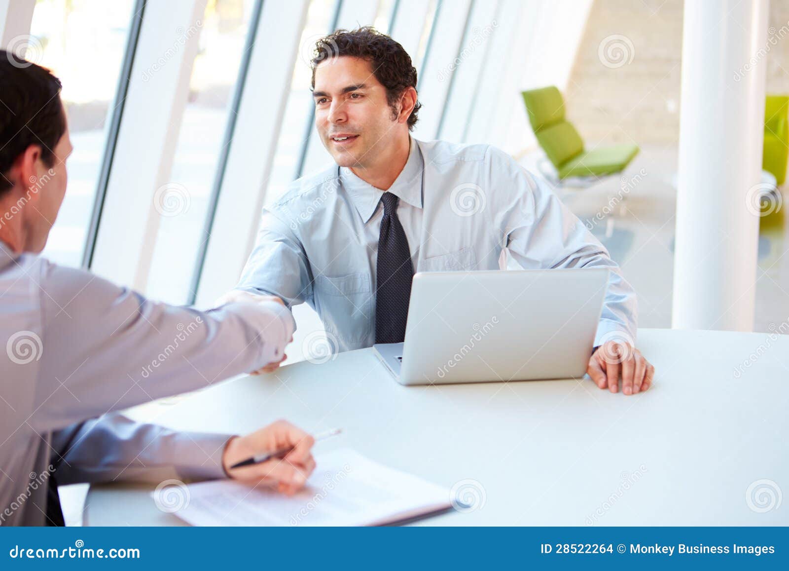 Two Businessmen Having Meeting Around Table in Modern Office Stock ...