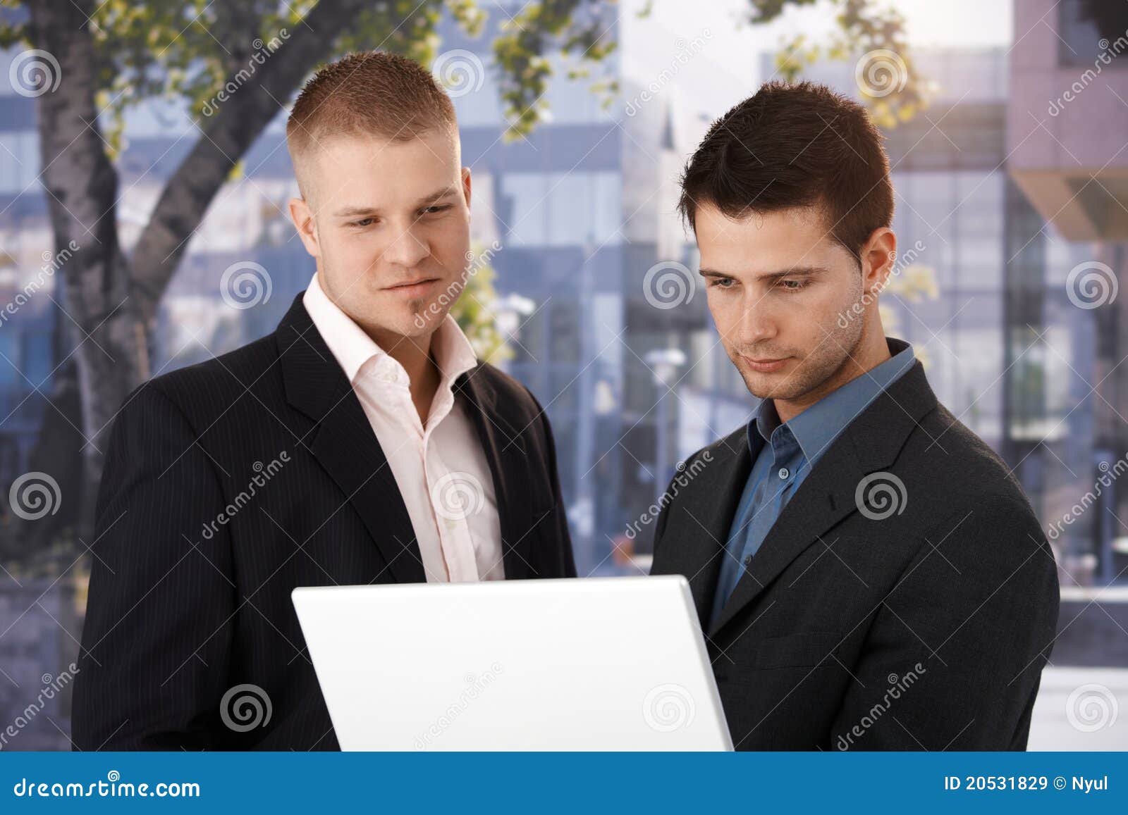 Two Businessmen with Laptop Outside of Office Stock Image - Image of ...