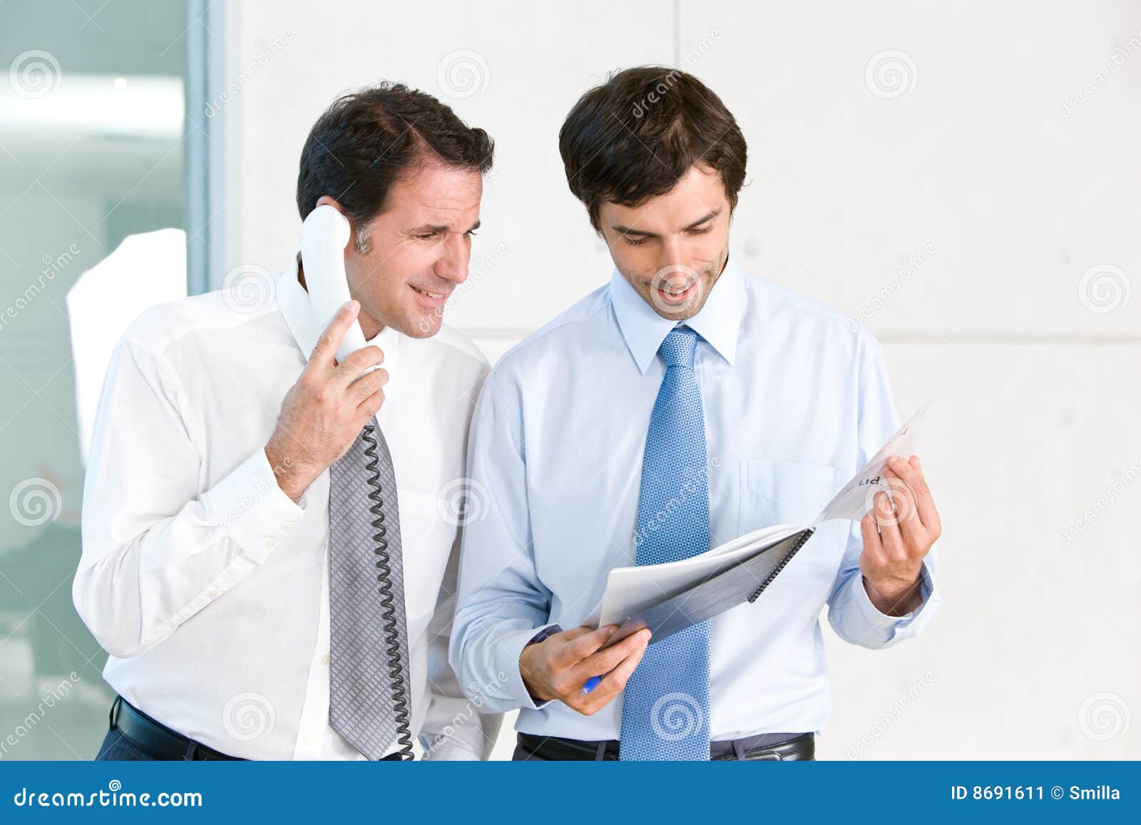 Two Businessmen Looking at Documents Stock Image - Image of businessmen ...