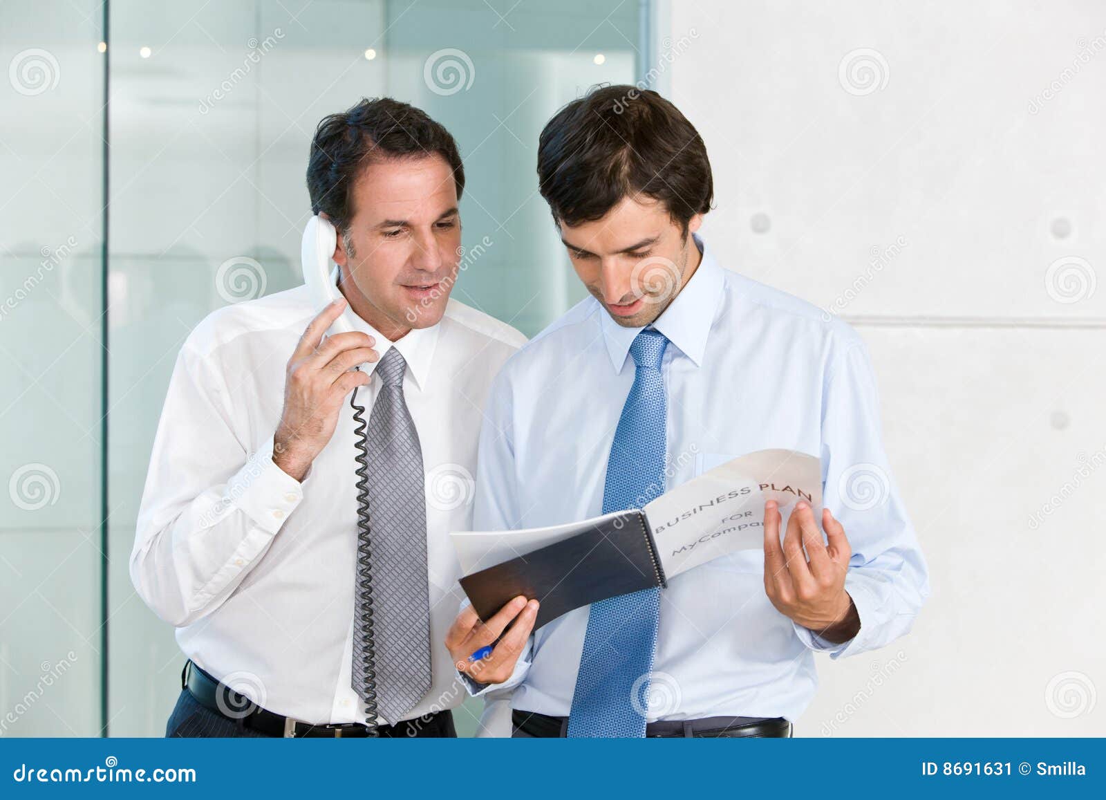 Two Businessmen Looking at Documents Stock Image - Image of employees ...