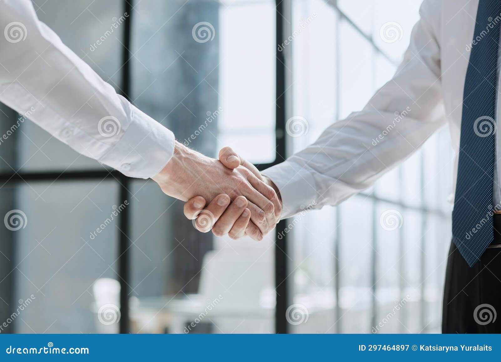 Two Businessmen Shake Hands on the Background of Empty Modern Office ...