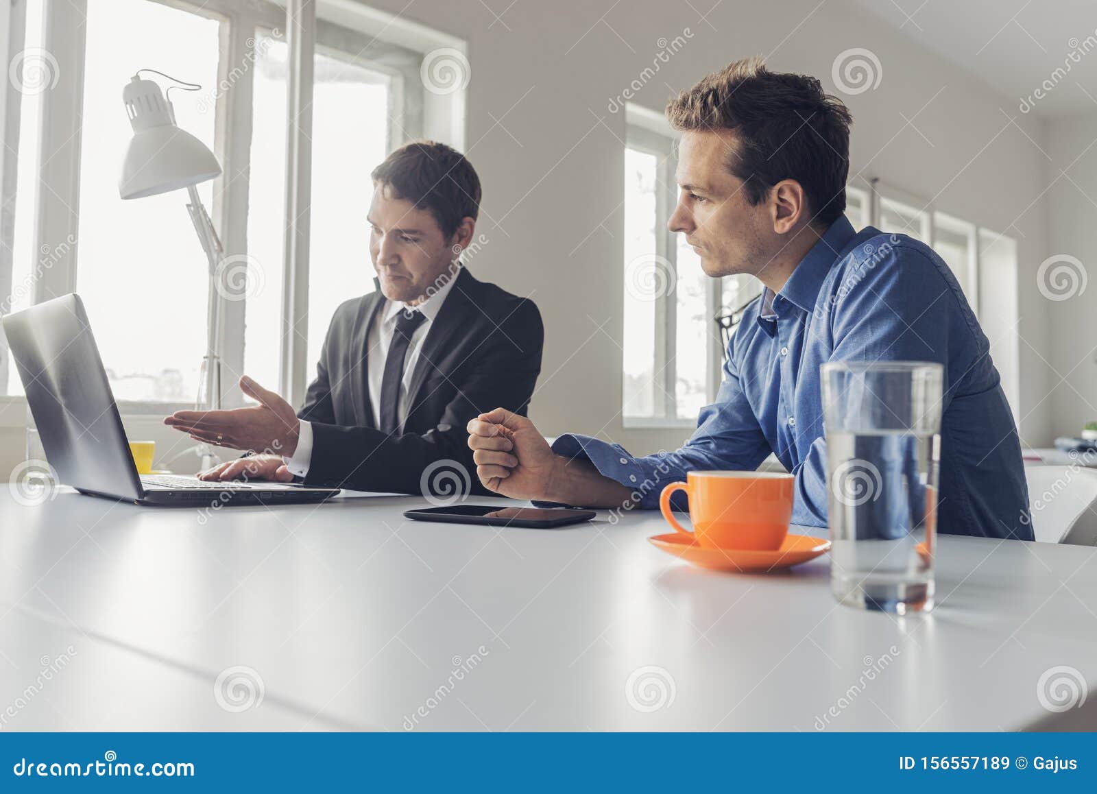 Two Businessmen Sitting at an Office Desk Working Together Stock Image ...