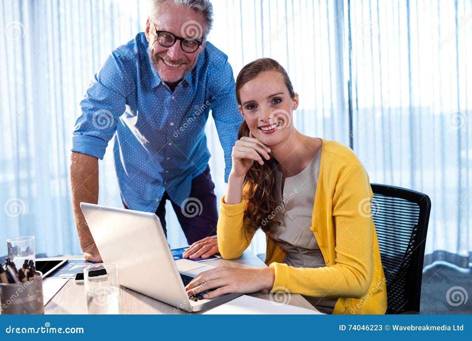 Two businessmen smiling stock image. Image of screen - 74046223