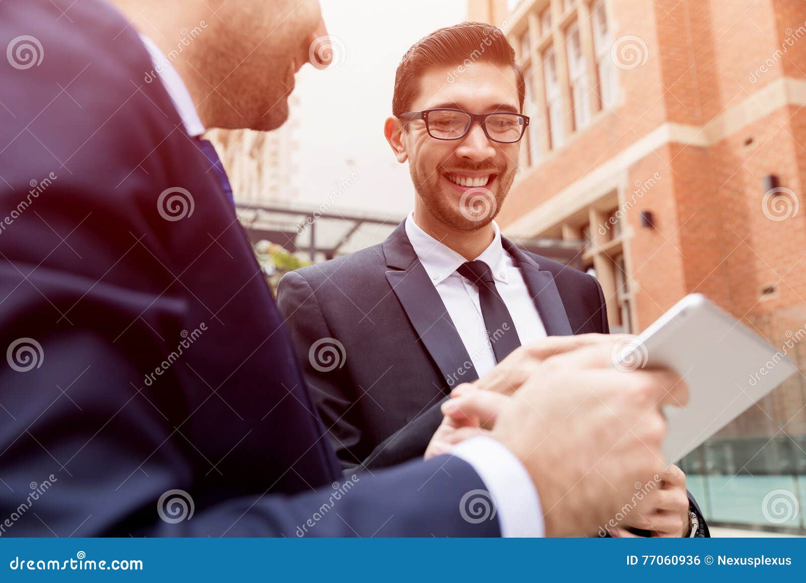 Two Businessmen Talking Outdoors Stock Photo - Image of chatting, suit ...
