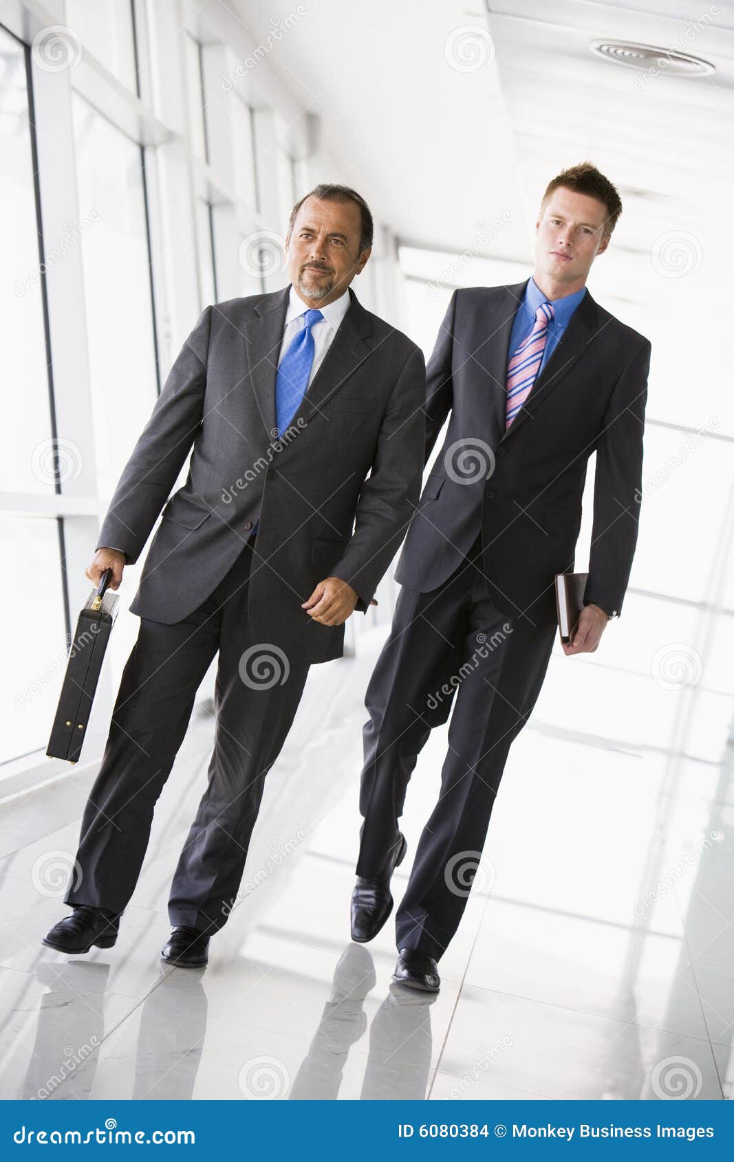 Two businessmen walking stock photo. Image of confident - 6080384