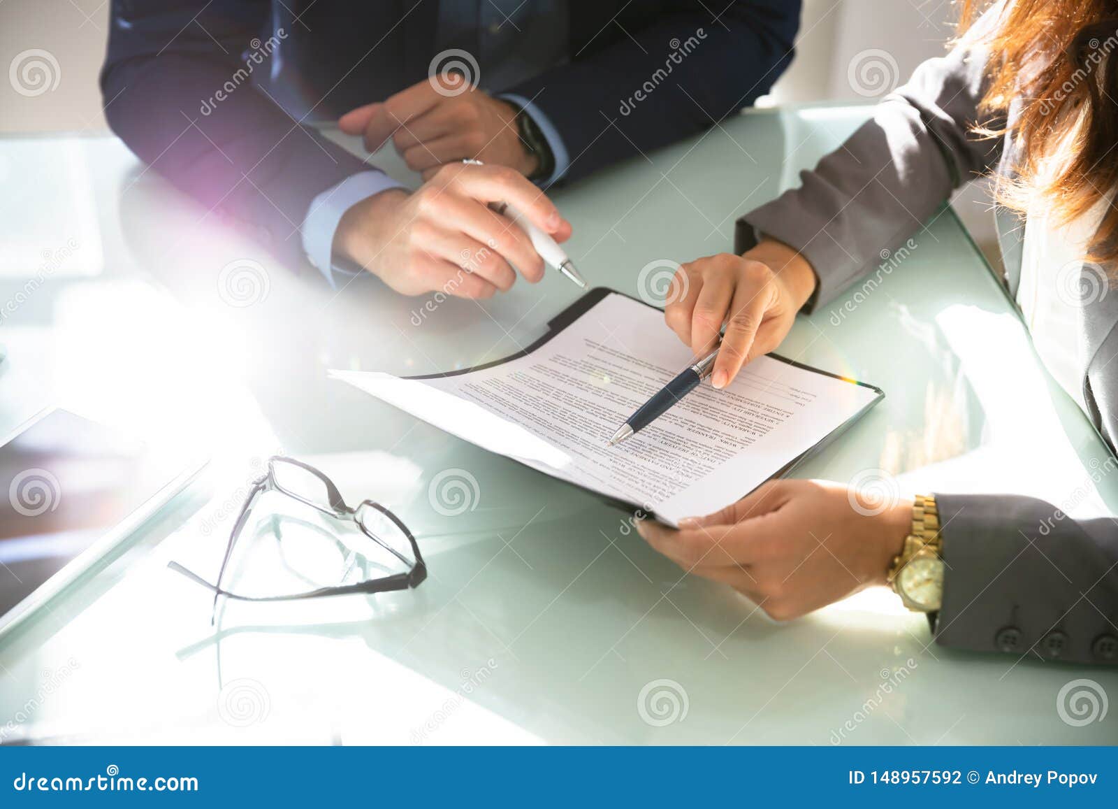 Two Businesspeople Analyzing Document Stock Photo - Image of discussing ...
