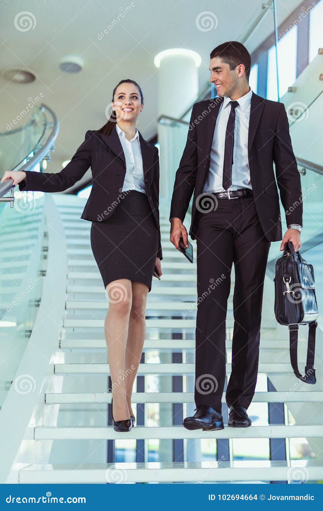 Two Businesspeople Talking As they Walk into the Office Stock Photo ... Two Businesspeople Talking As they Walk into the Office Stock Photo ...