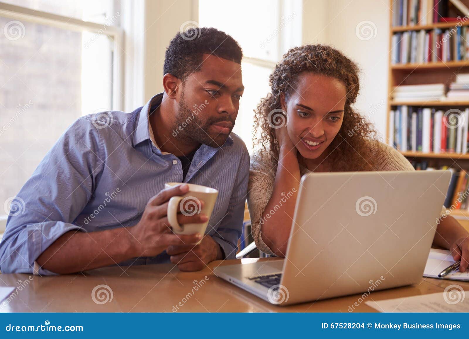 Two Businesspeople Working at Laptop in Office Stock Photo - Image of ...