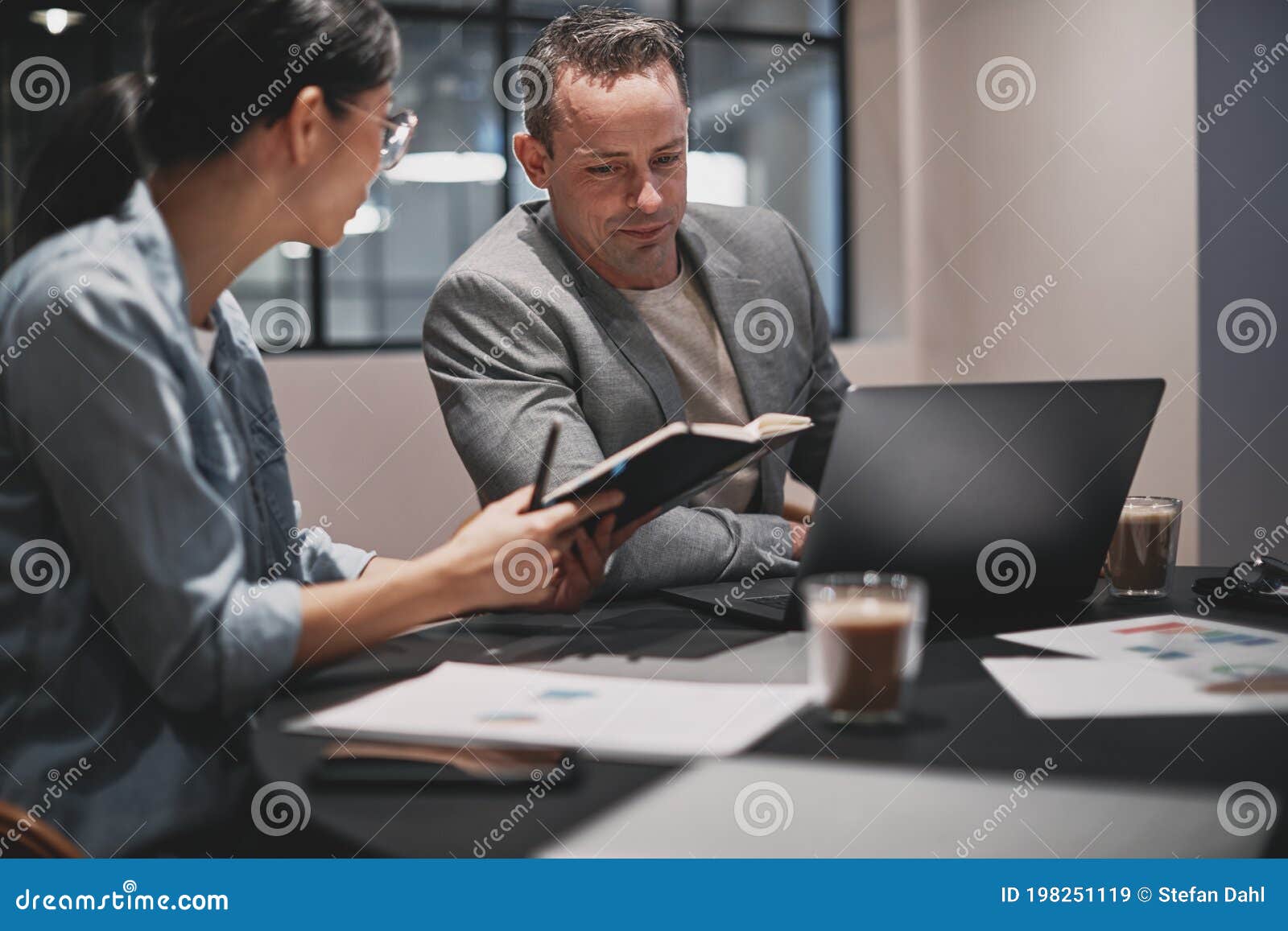 Two Businesspeople Working Together at a Table in an Office Stock Image ...