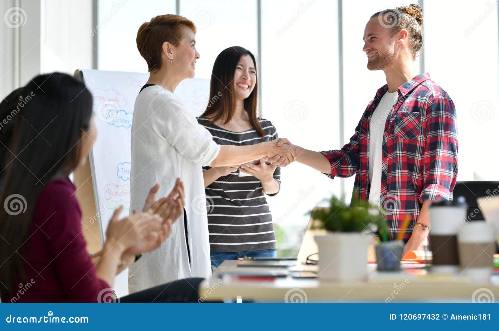 Two Businesspersons Shaking Hands in Agreement with Congratulating ...