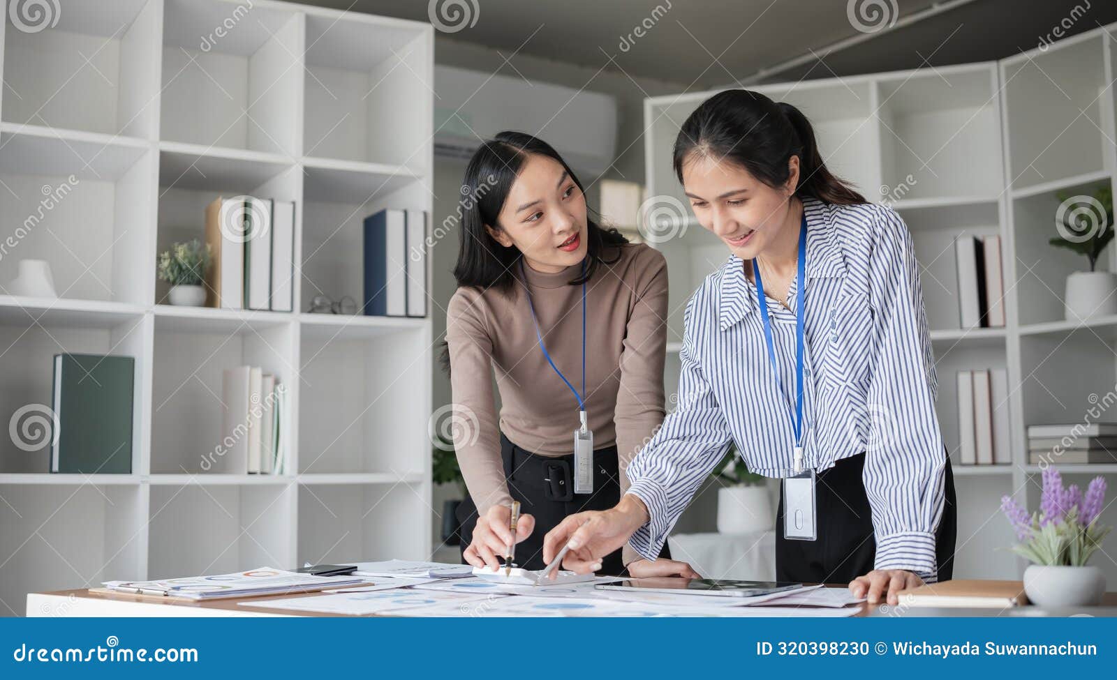 Two Businesswomen Collaborating on Project in Modern Office. Concept of ...