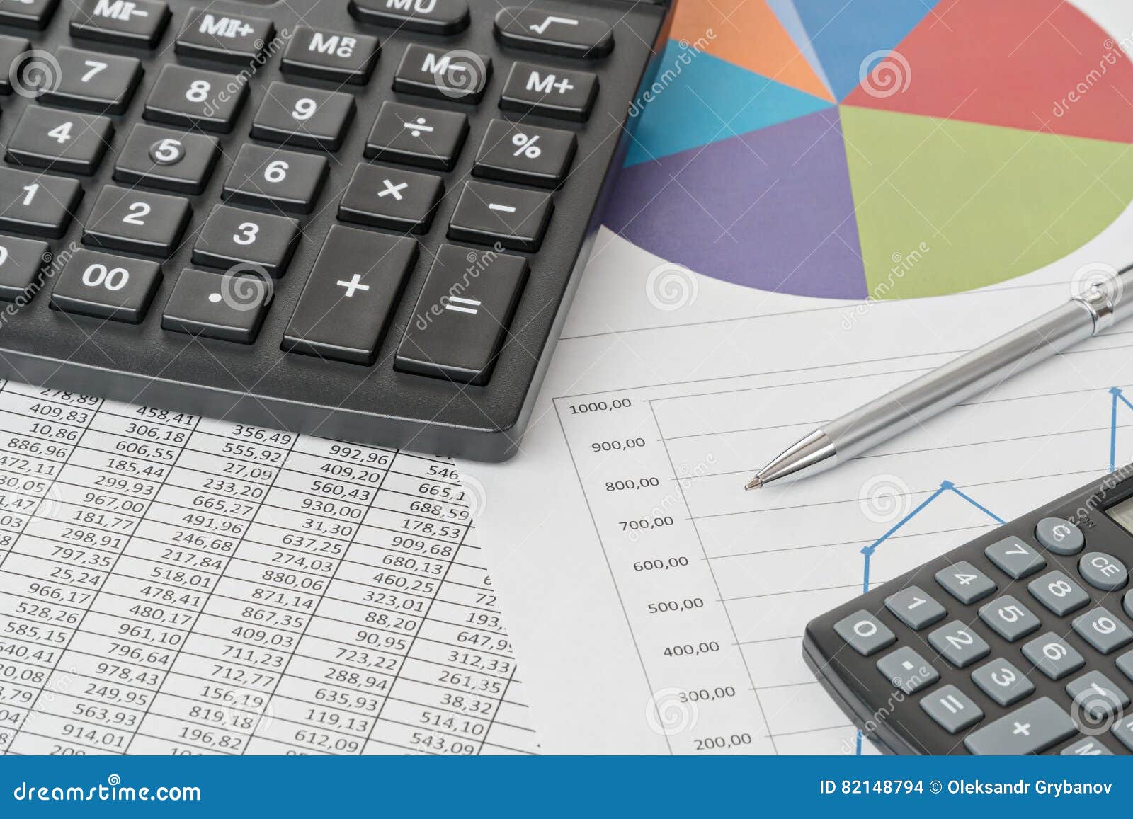 Two calculator and graphs stock photo. Image of account - 82148794