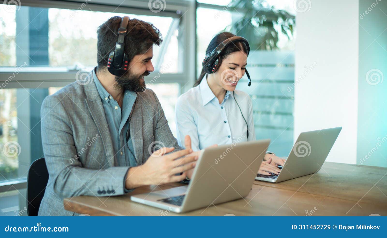 Two Call Center Agent Smiling Happy Working at the Office. Stock Image ...