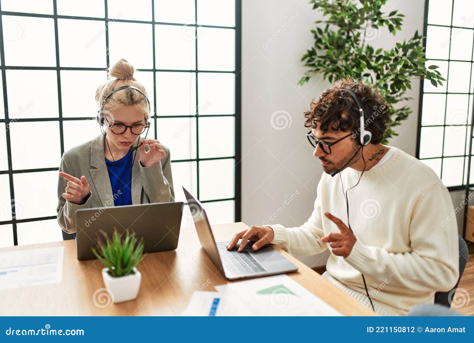 Two Call Center Agents Working at the Office Stock Photo - Image of ...