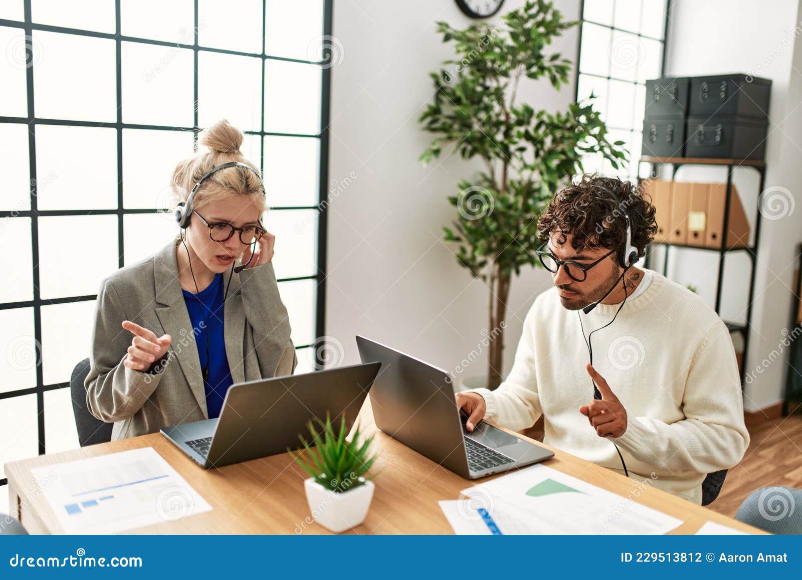 Two Call Center Agents Working at the Office Stock Photo - Image of ...