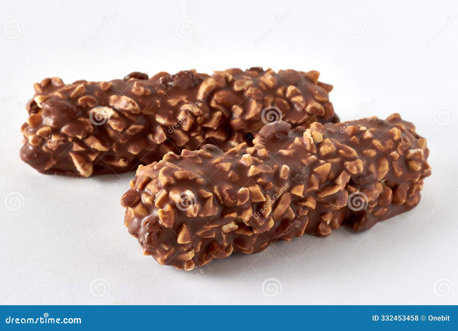 Two Candy Bars Covered with Peanuts and Chocolate on a White Table ...