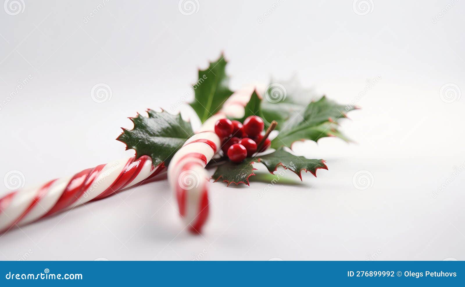 Two Candy Canes With Holly Leaves And Red Berries On Them Stock