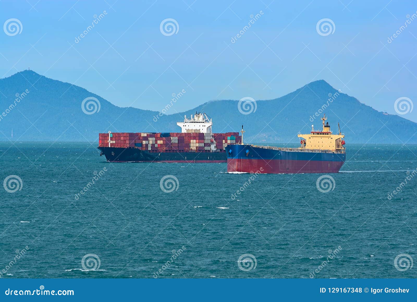 Two cargo ships underway. stock photo. Image of sailing - 129167348